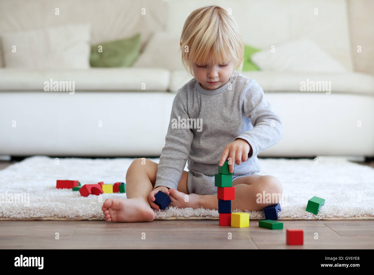 Toddler playing with wooden blocks Stock Photo - Alamy