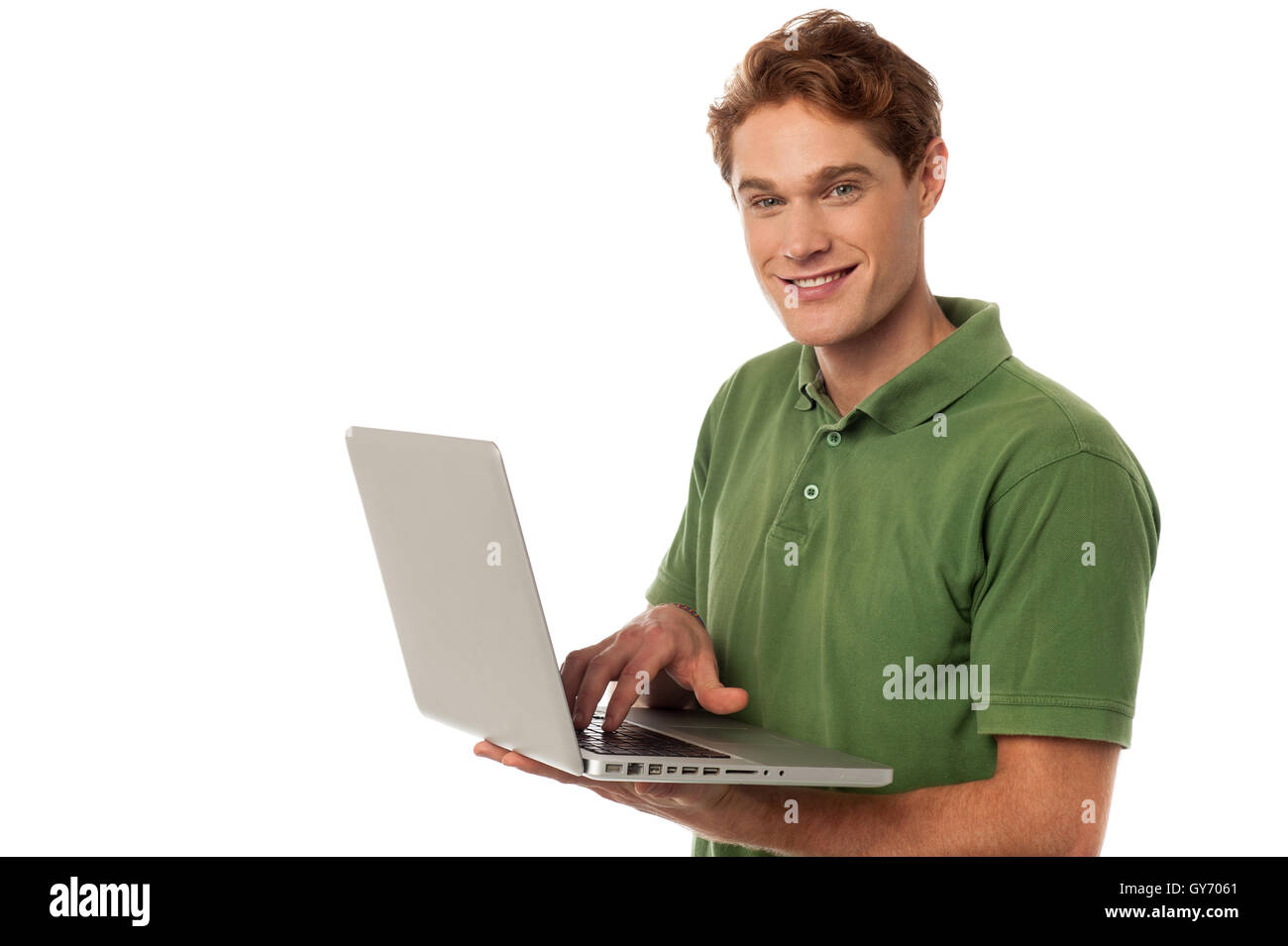 Handsome guy operating laptop Stock Photo - Alamy
