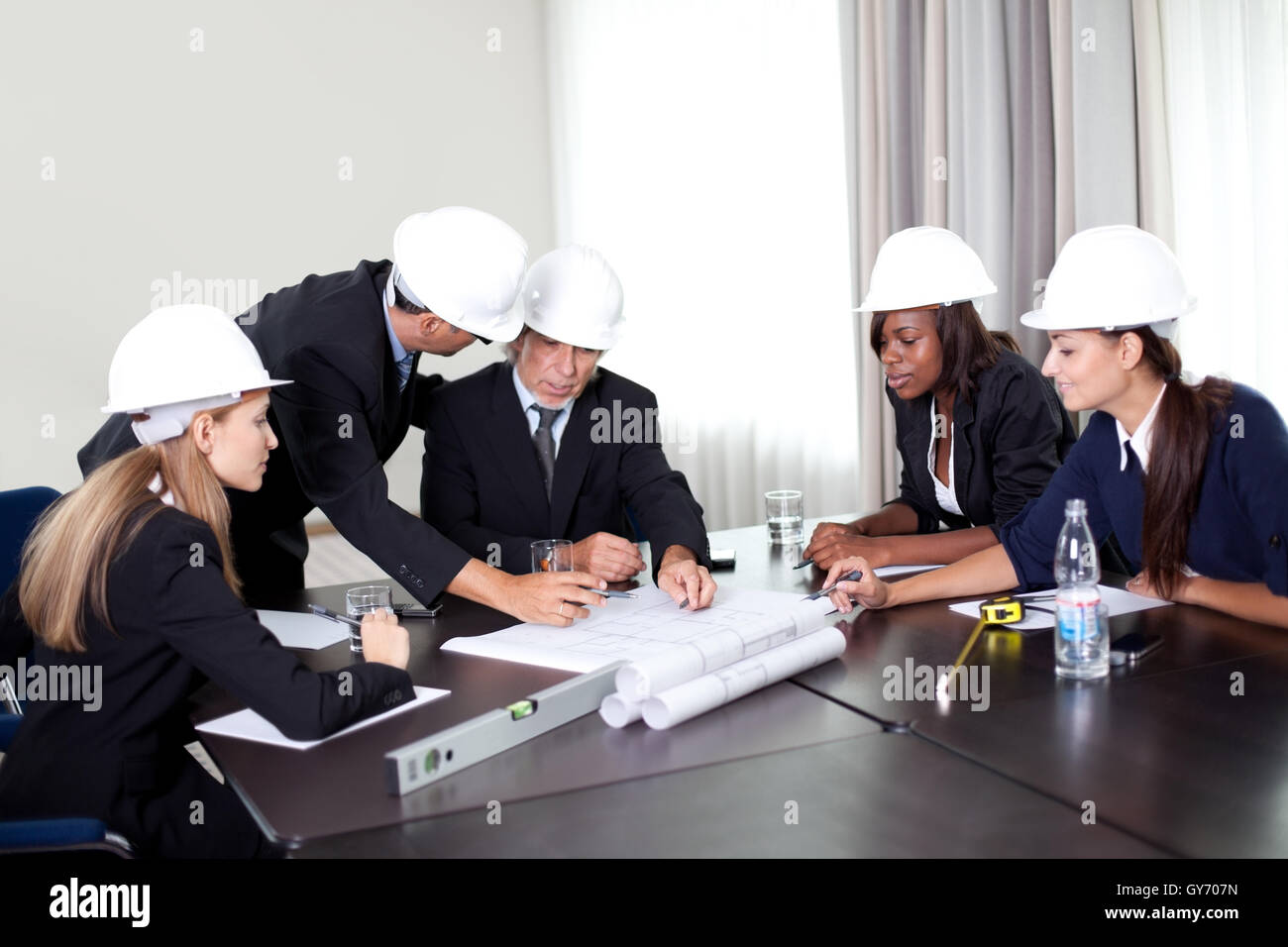 Successful group of architects discussing Stock Photo - Alamy