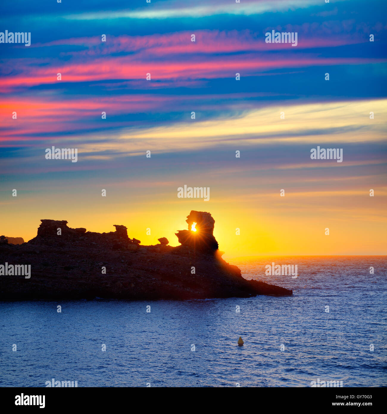 Menorca sunset in Cala Morell at Ses torretes beach Stock Photo - Alamy