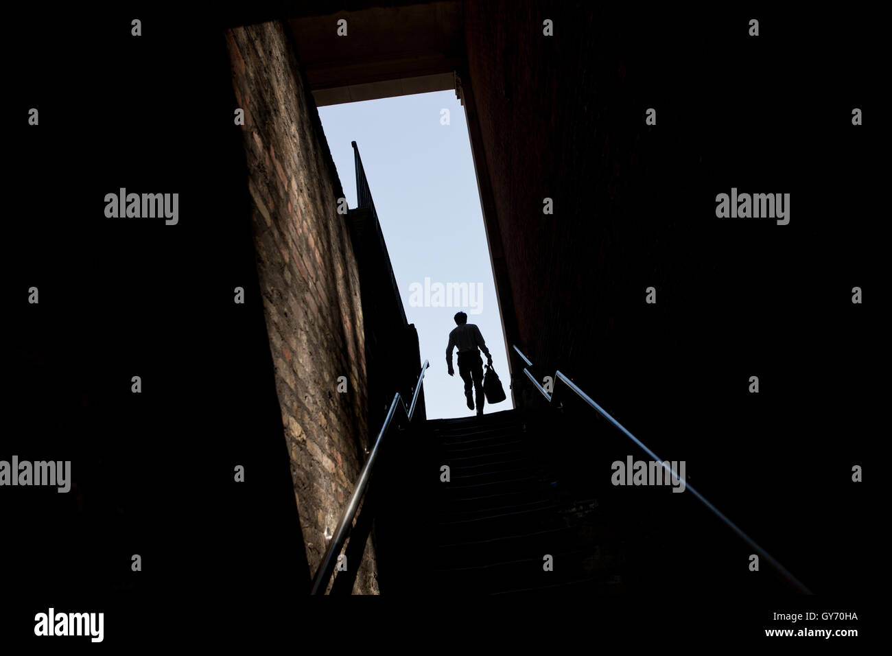 Color street style photograph of a man rising up the stairs in London ...