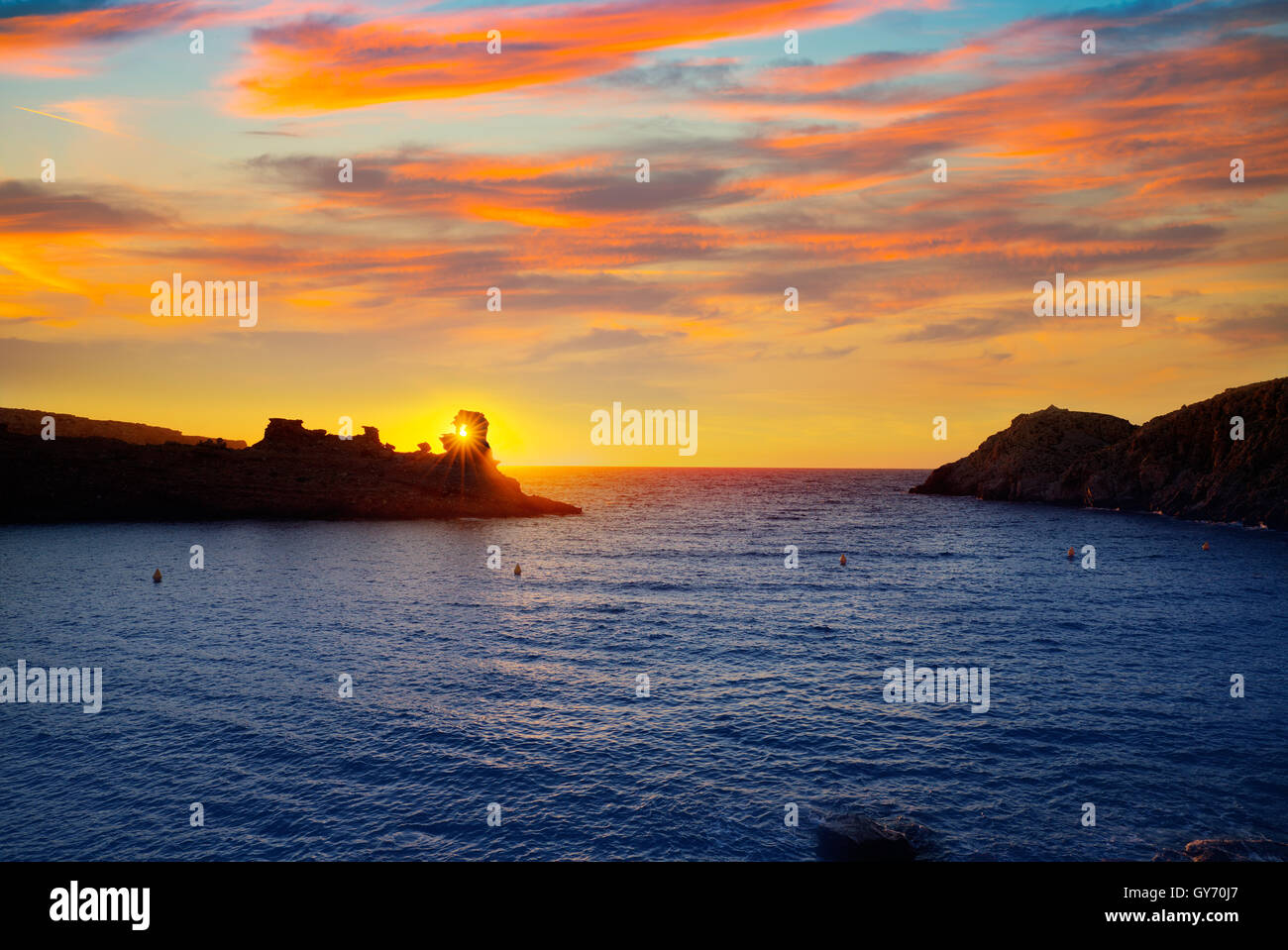 Menorca sunset in Cala Morell at Ses torretes beach Stock Photo - Alamy