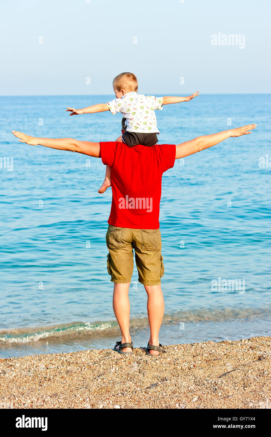 Father and son on the beach portray flight Stock Photo - Alamy