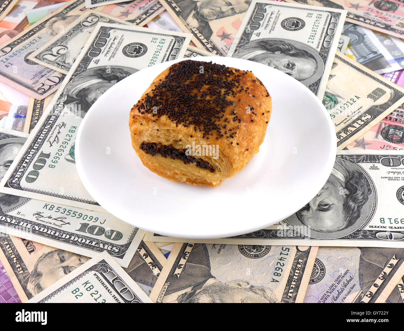 sweet cake on money background Stock Photo - Alamy