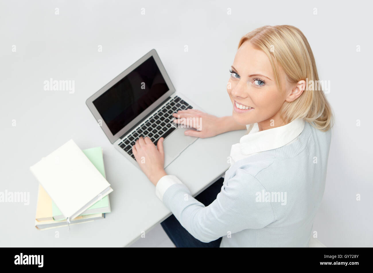 Beautiful student girl studying with laptop Stock Photo - Alamy