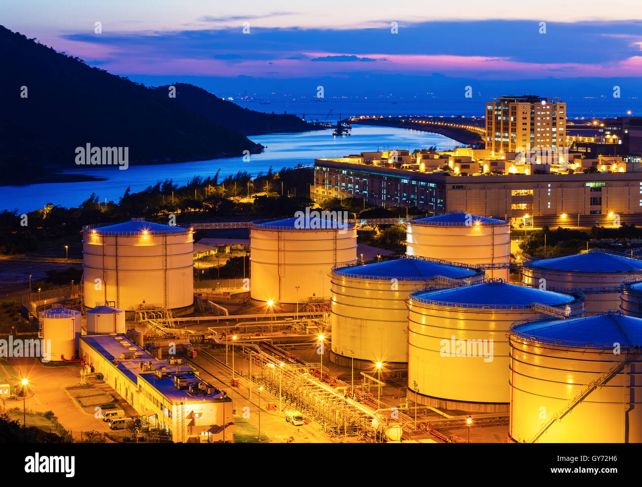 Oil tanks for cargo service at night Stock Photo - Alamy