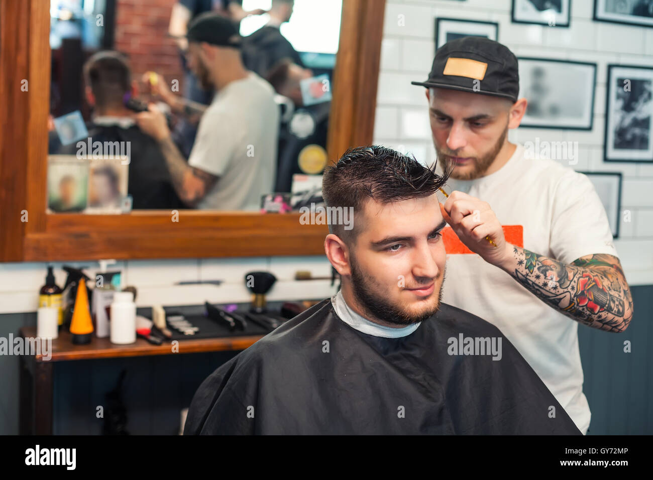 Young man having hair cutted Stock Photo - Alamy