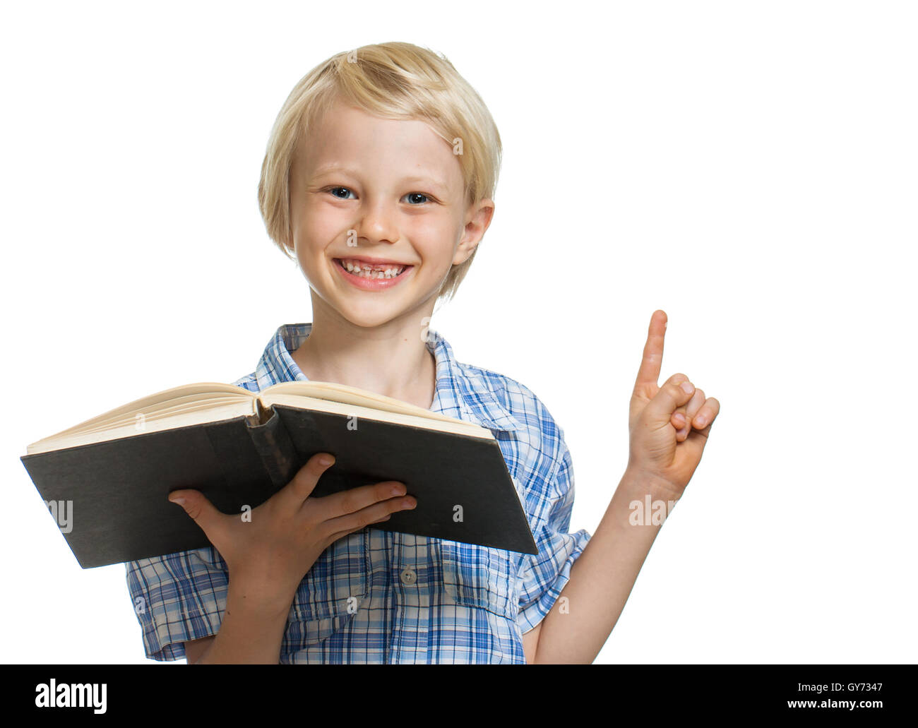 Happy boy holding book and pointing Stock Photo - Alamy