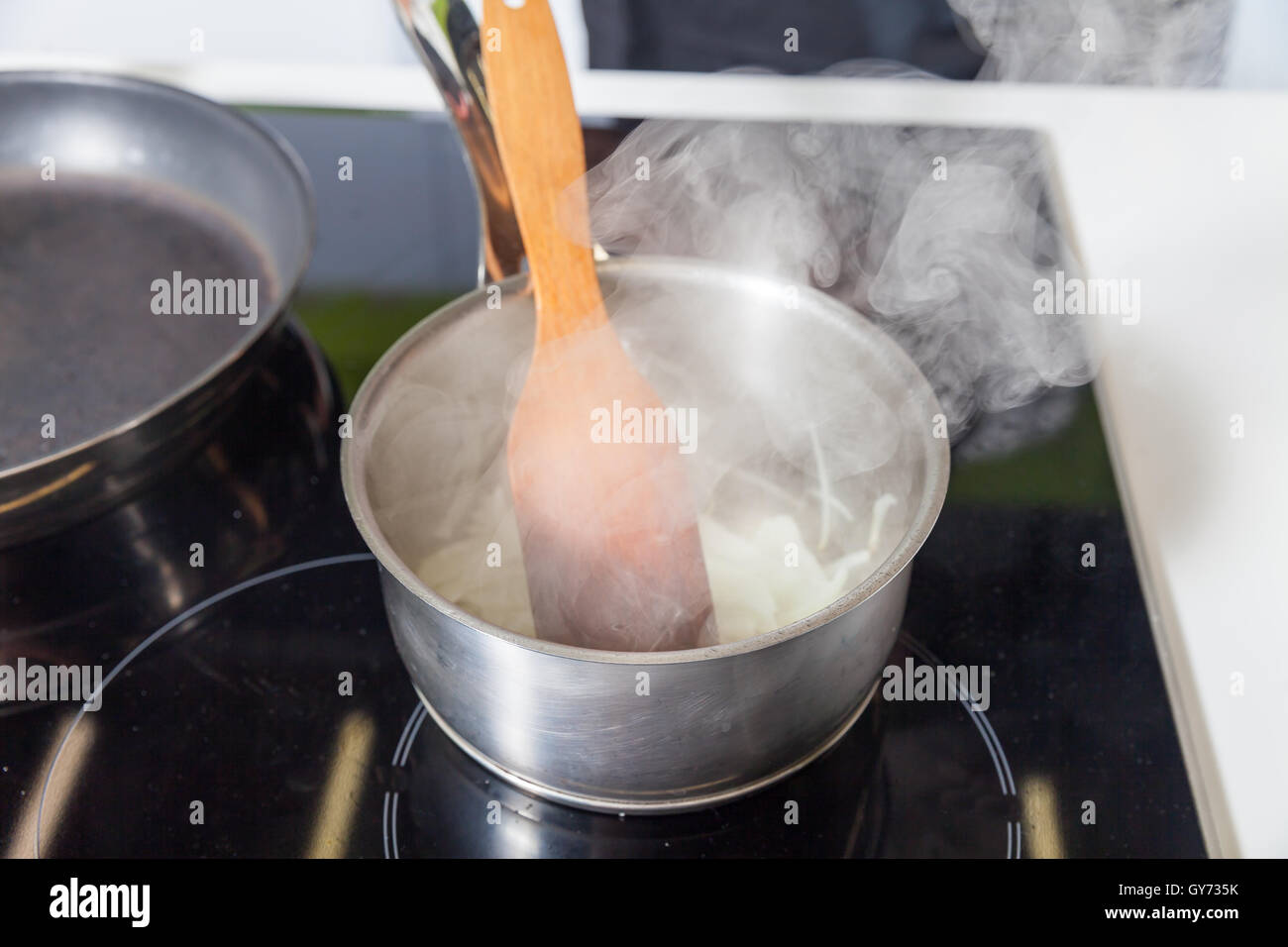 Pan and pot on the stove Stock Photo - Alamy