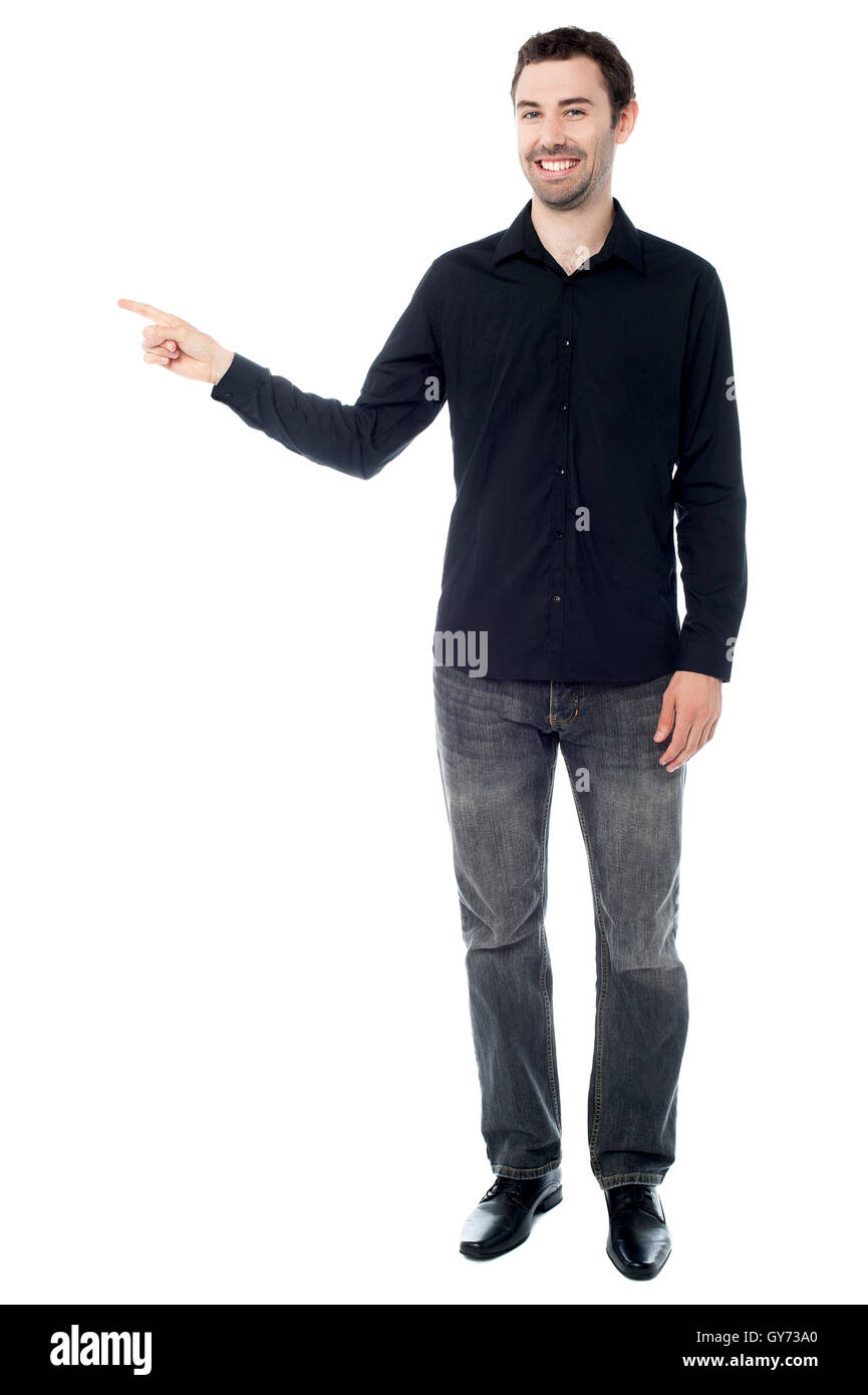 Stylish young guy pointing away Stock Photo - Alamy