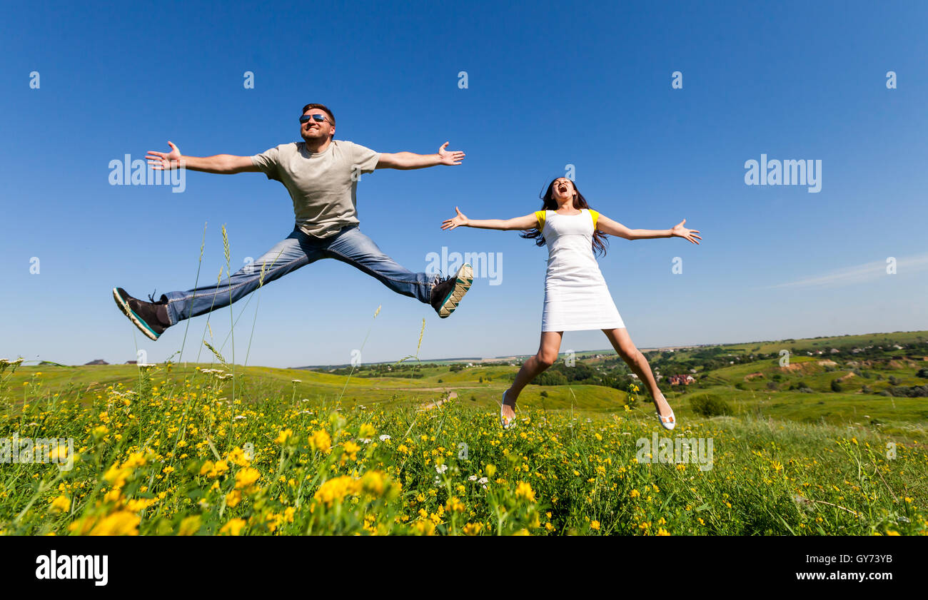 Couple having fun on the meadow Stock Photo - Alamy