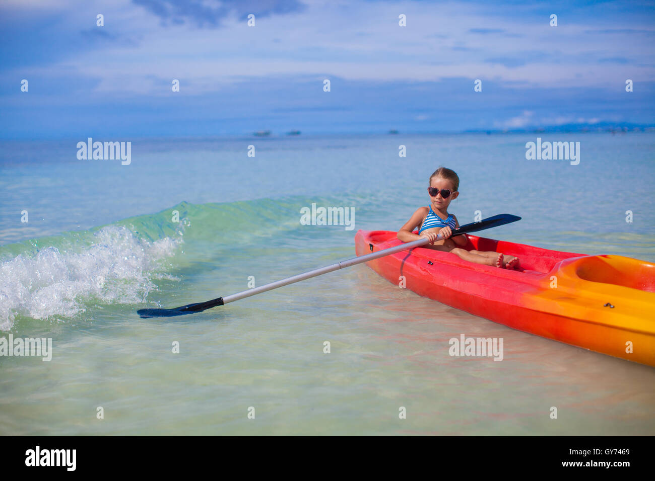 Little adorable girl kayaking in the clear blue ocean Stock Photo - Alamy