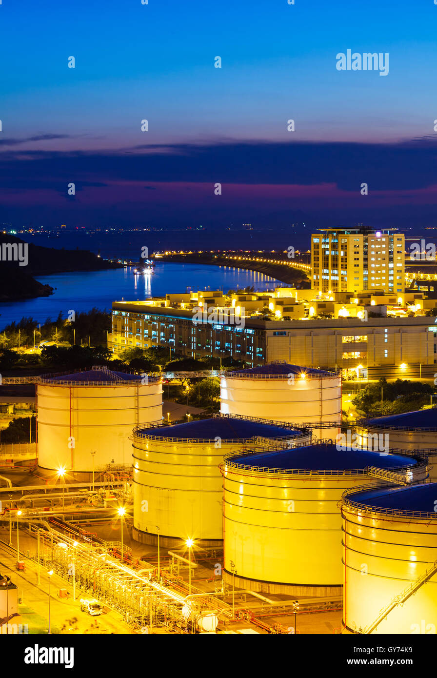 Oil tanks for cargo service at night Stock Photo - Alamy