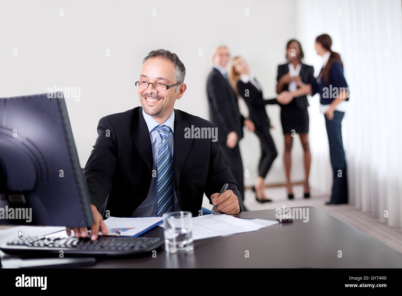 Confident happy businessman writing notes Stock Photo - Alamy