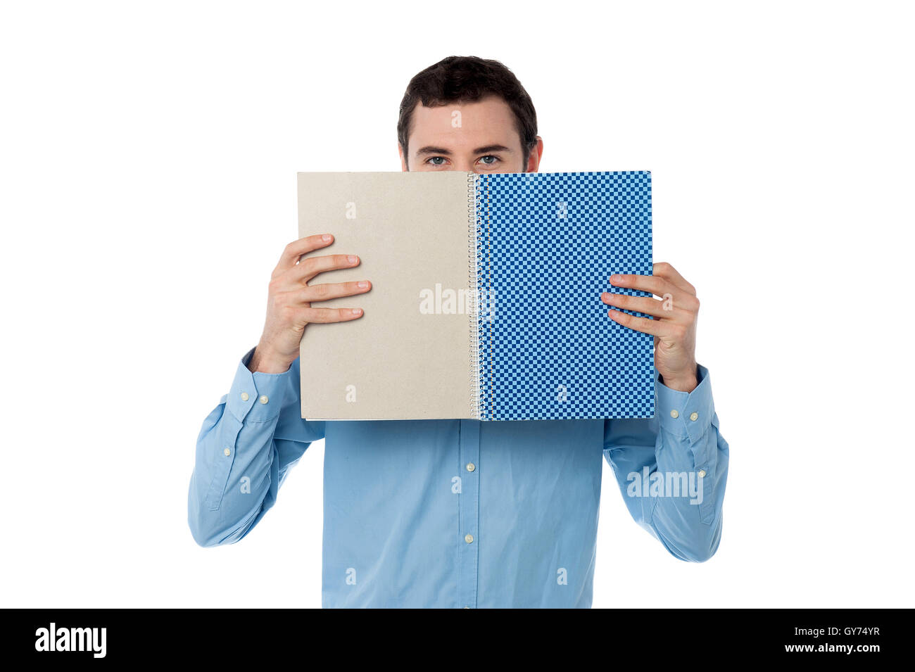 Young man hiding his face with notebook Stock Photo - Alamy