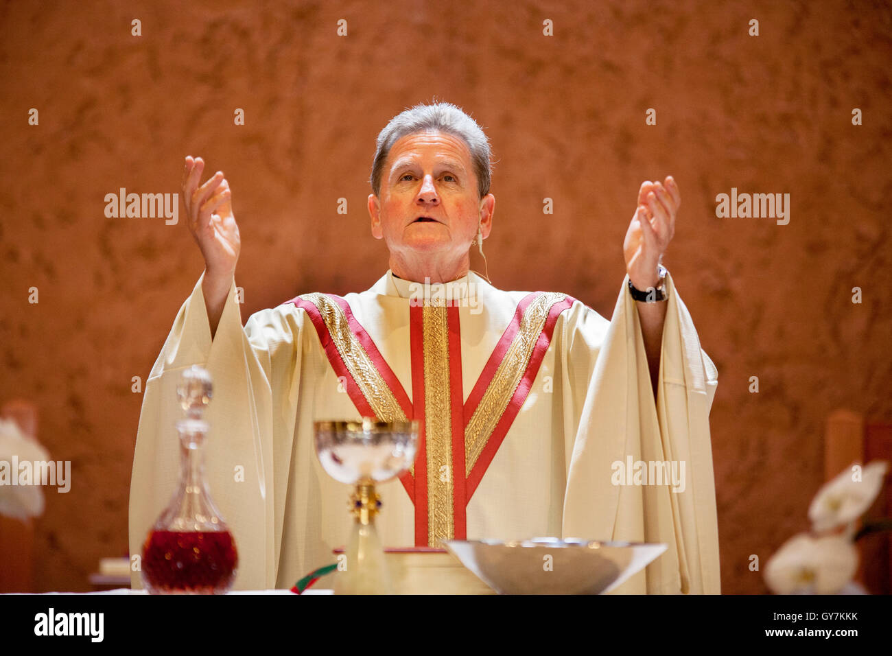Wearing formal robes, a monsignor conducts mass at a Laguna Niguel, CA ...