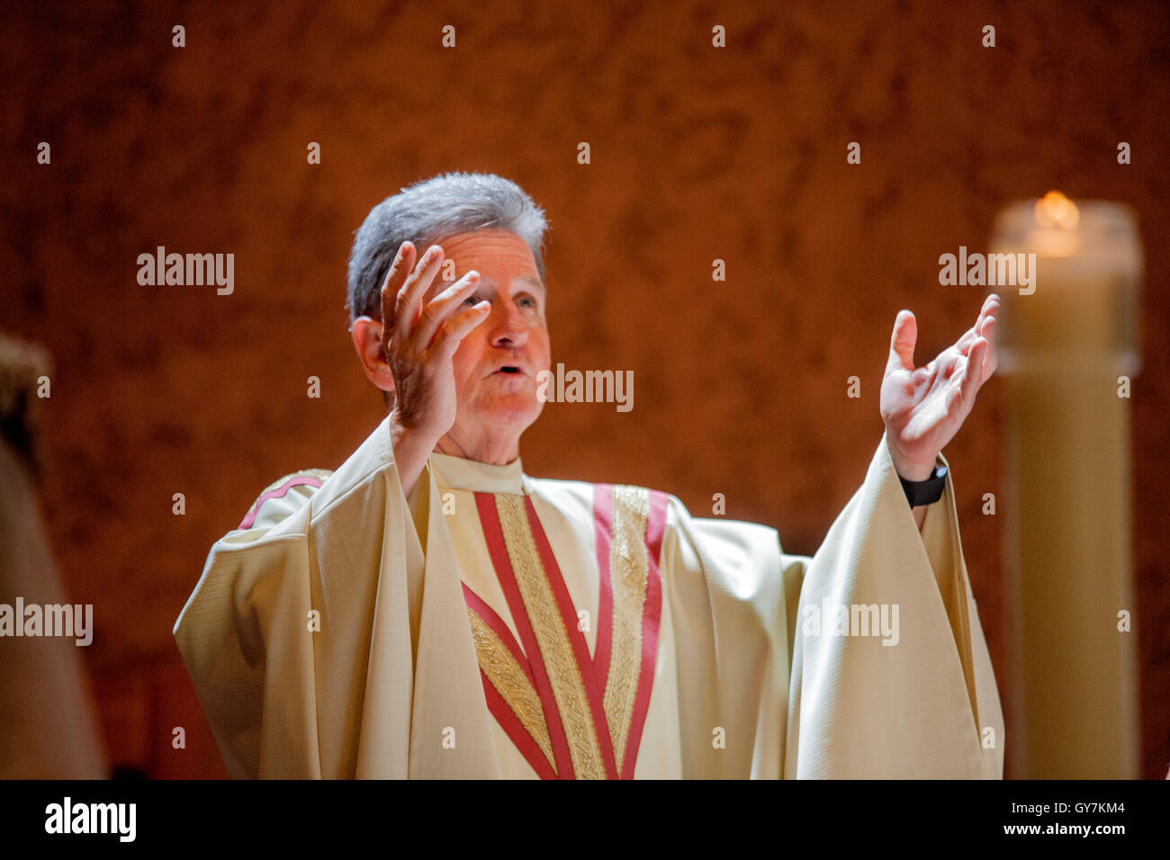 Wearing formal robes, a monsignor conducts mass at a Laguna Niguel, CA ...