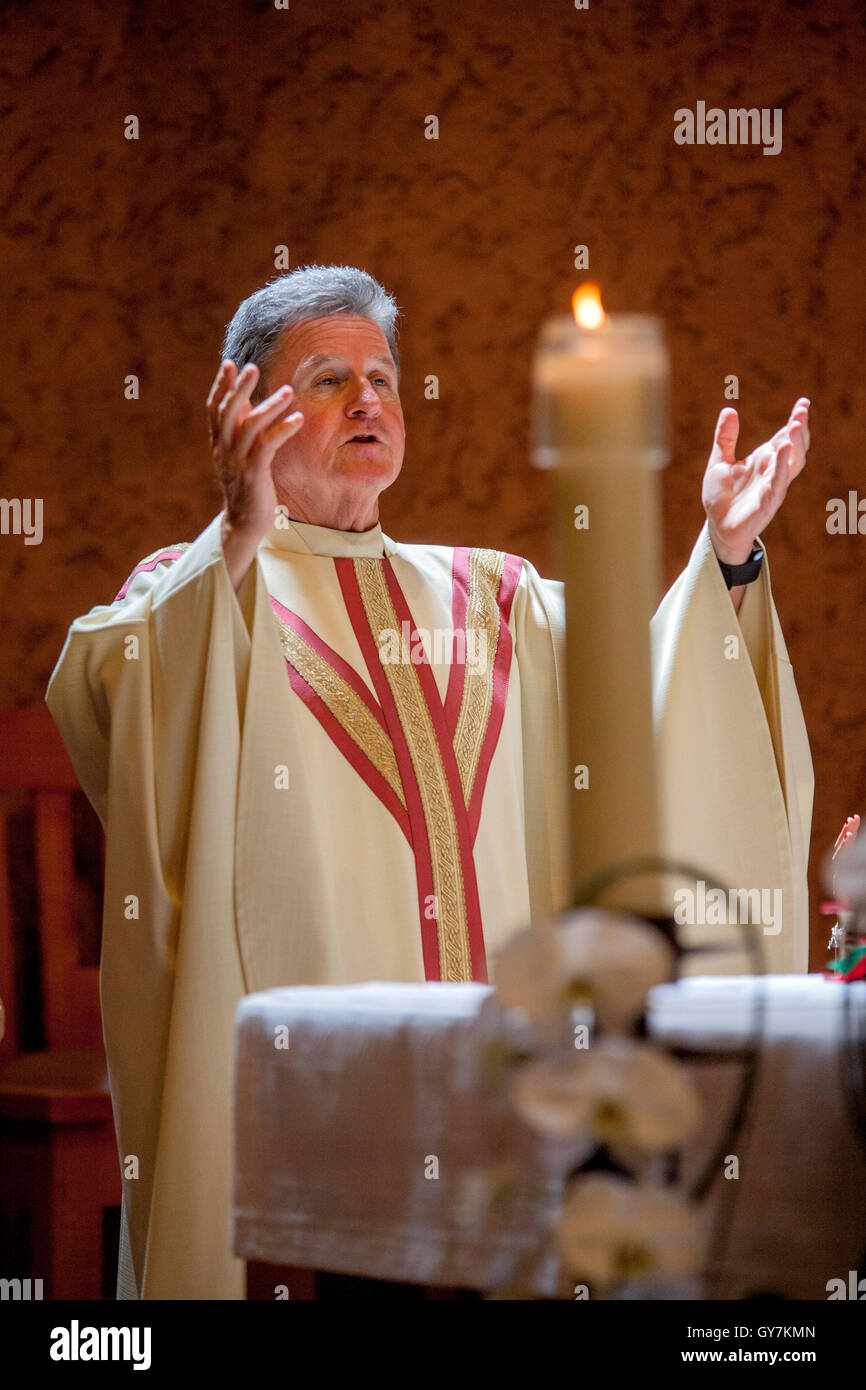 Wearing formal robes, a monsignor conducts mass at a Laguna Niguel, CA ...