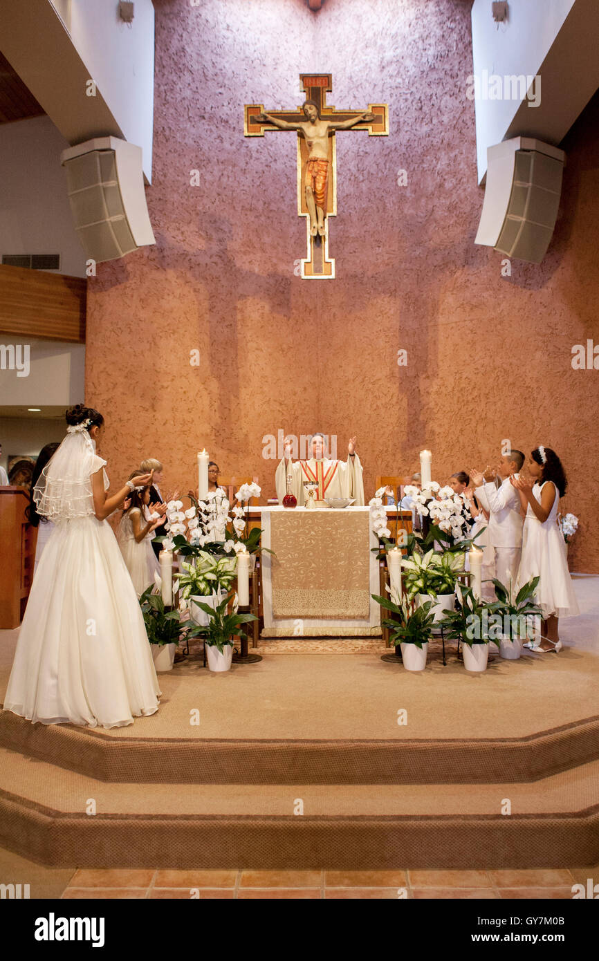 Formally dressed Hispanic and Caucasian children sing a hymn during ...