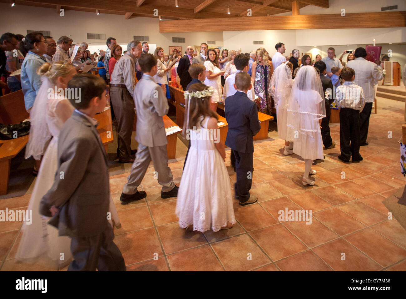 Formally dressed children march to First Communion mass at a Laguna ...