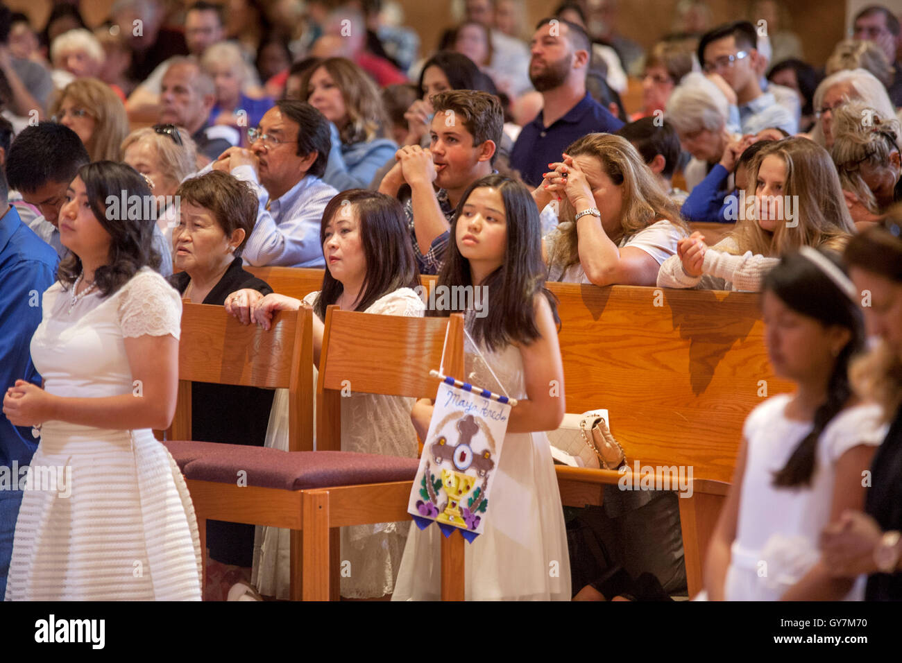 Formally dressed teen girls and parents pray at a Laguna Niguel, CA ...