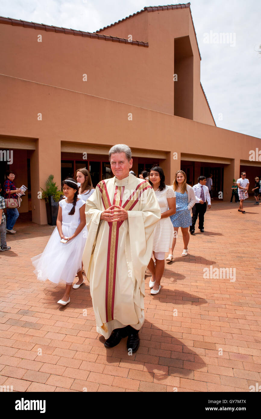 A robed monsignor leads a proud procession of formally dressed ...