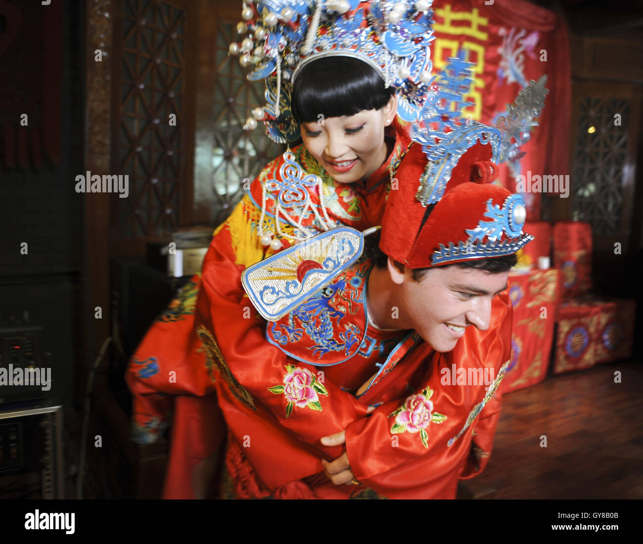 Beijing, China. 12th June, 2016. American groom Bryan Shapiro carries ...