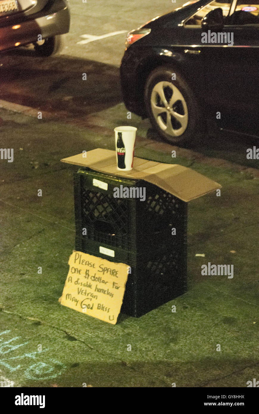 homeless mans sign and seat Stock Photo - Alamy