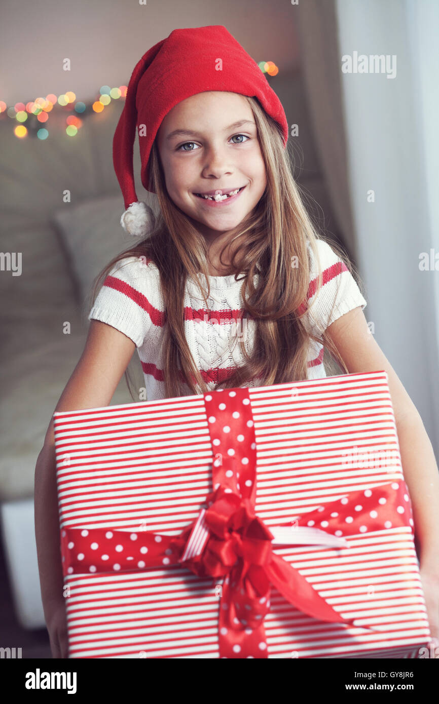 Child holding big gift Stock Photo - Alamy