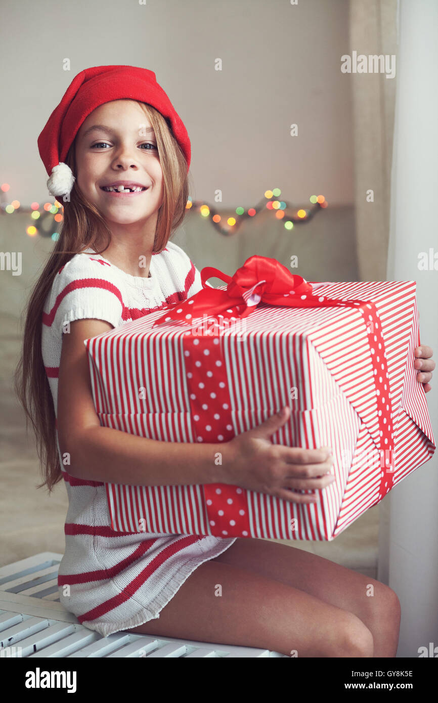 Child holding big gift Stock Photo - Alamy