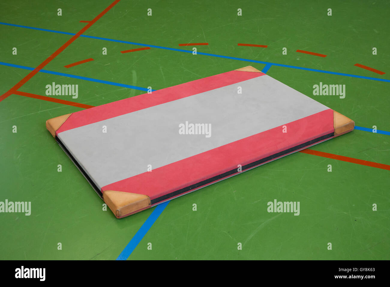 Very old red mat on a blue court Stock Photo - Alamy