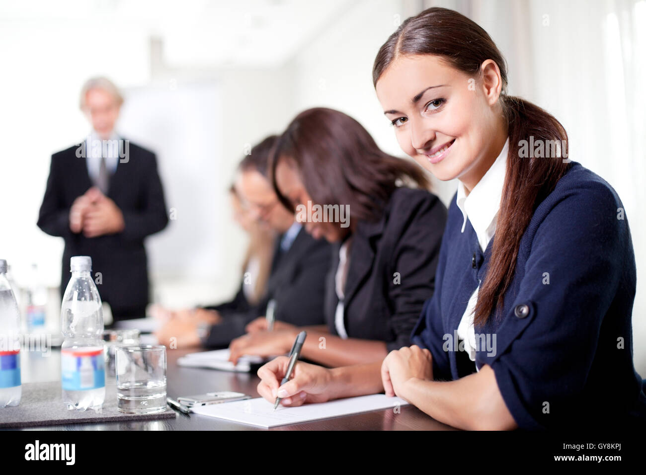 Writing notes during a business training Stock Photo - Alamy