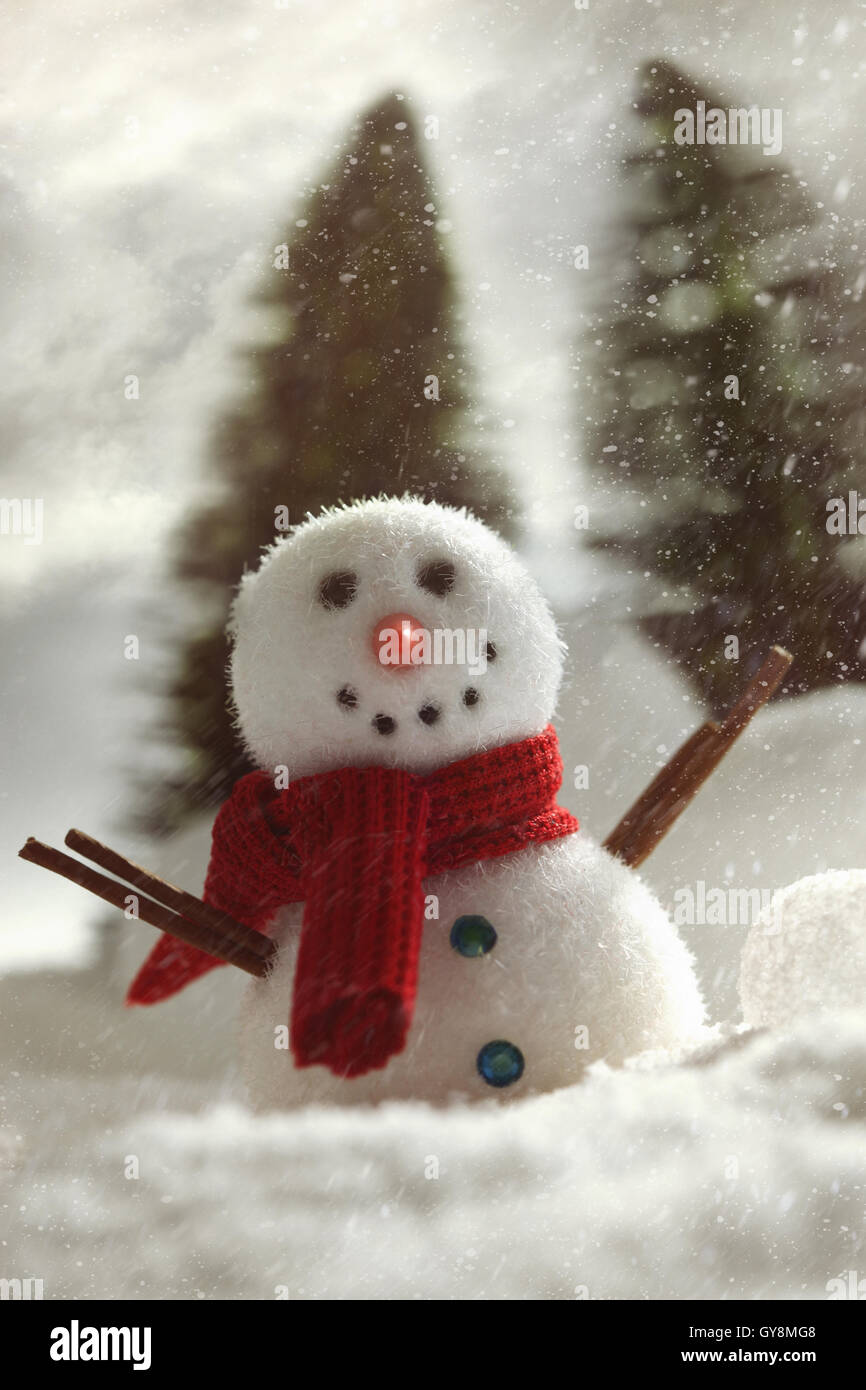 Little snowman with winter snow background Stock Photo - Alamy