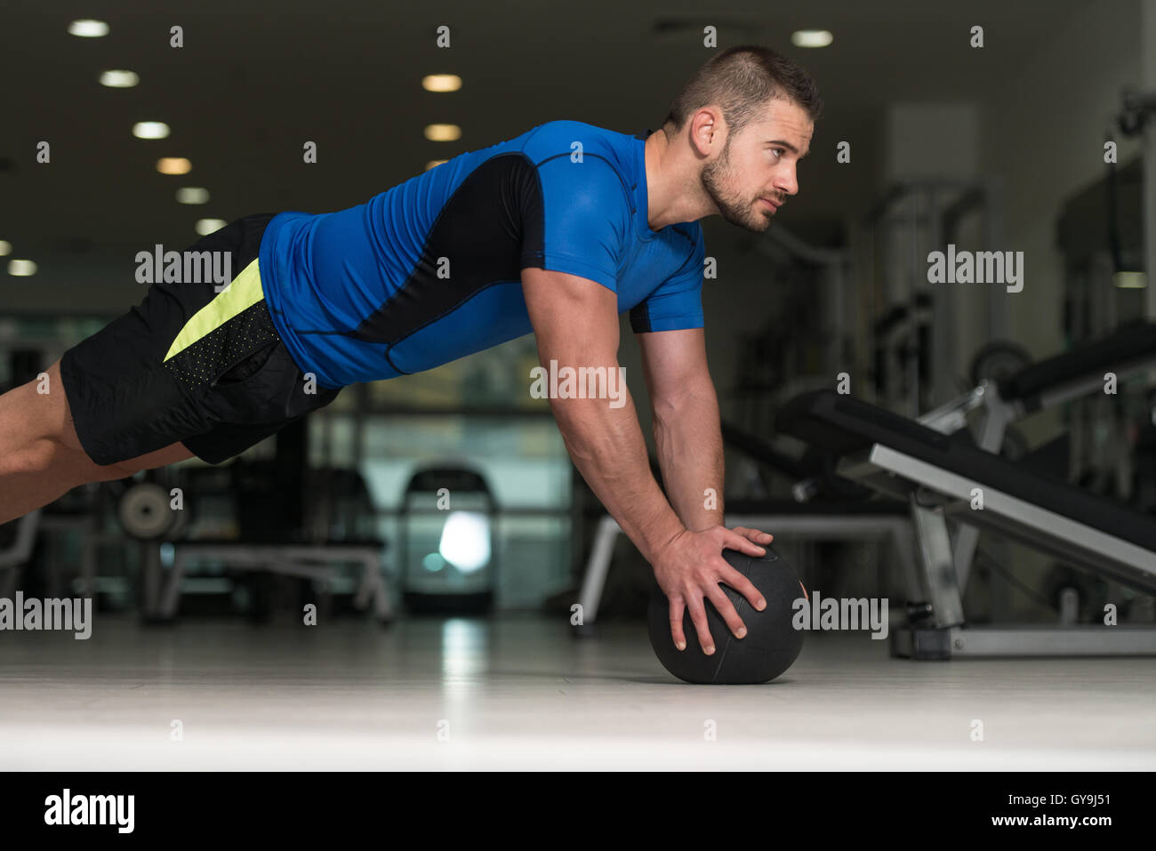 Personal Trainer Doing Pushups With Medicine Ball As Part Of ...