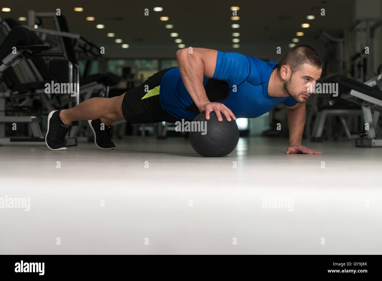 Personal Trainer Doing Pushups With Medicine Ball As Part Of ...