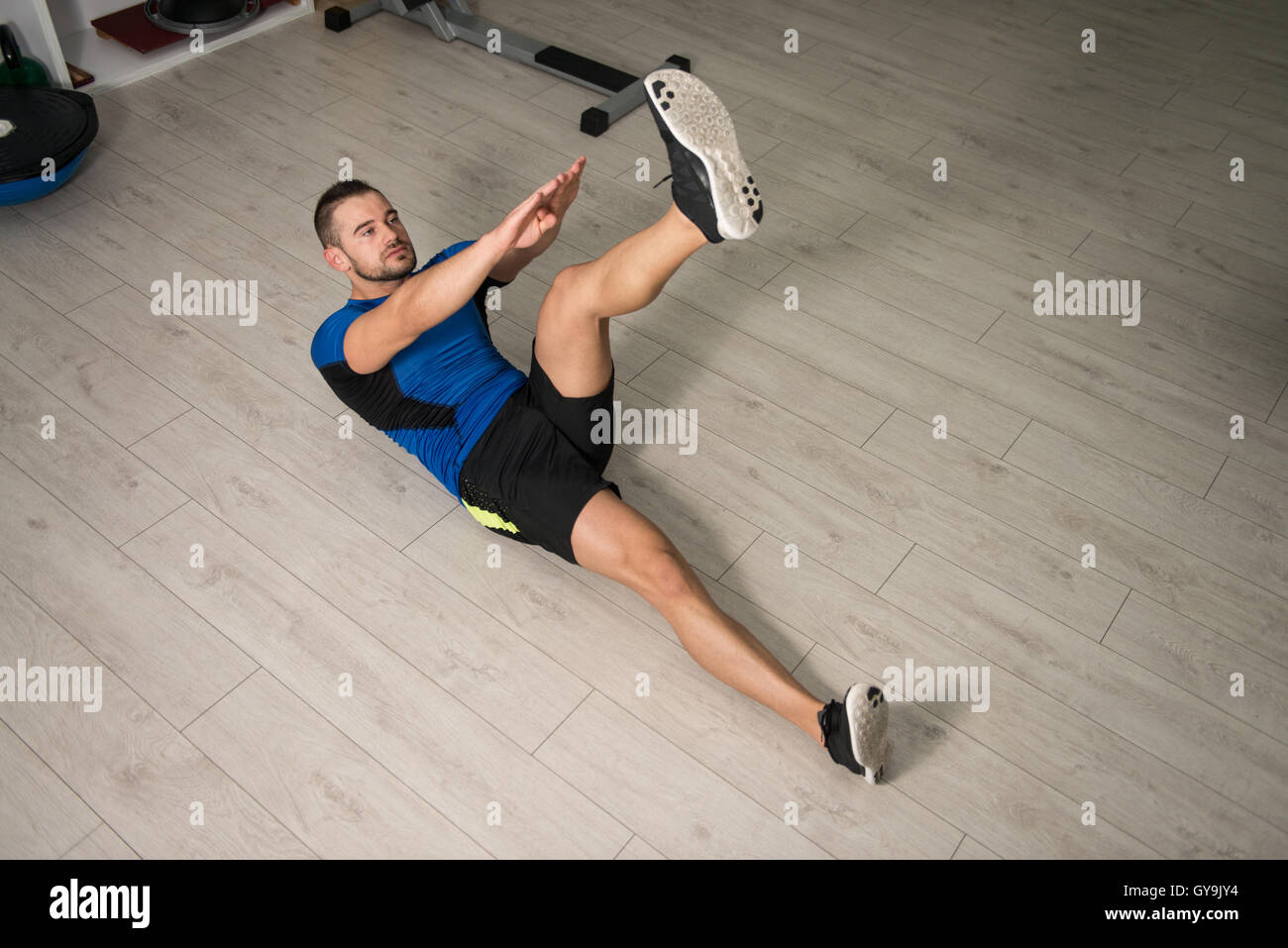 Personal Trainer Performing Abdominal Exercise On Floor - One Of The ...