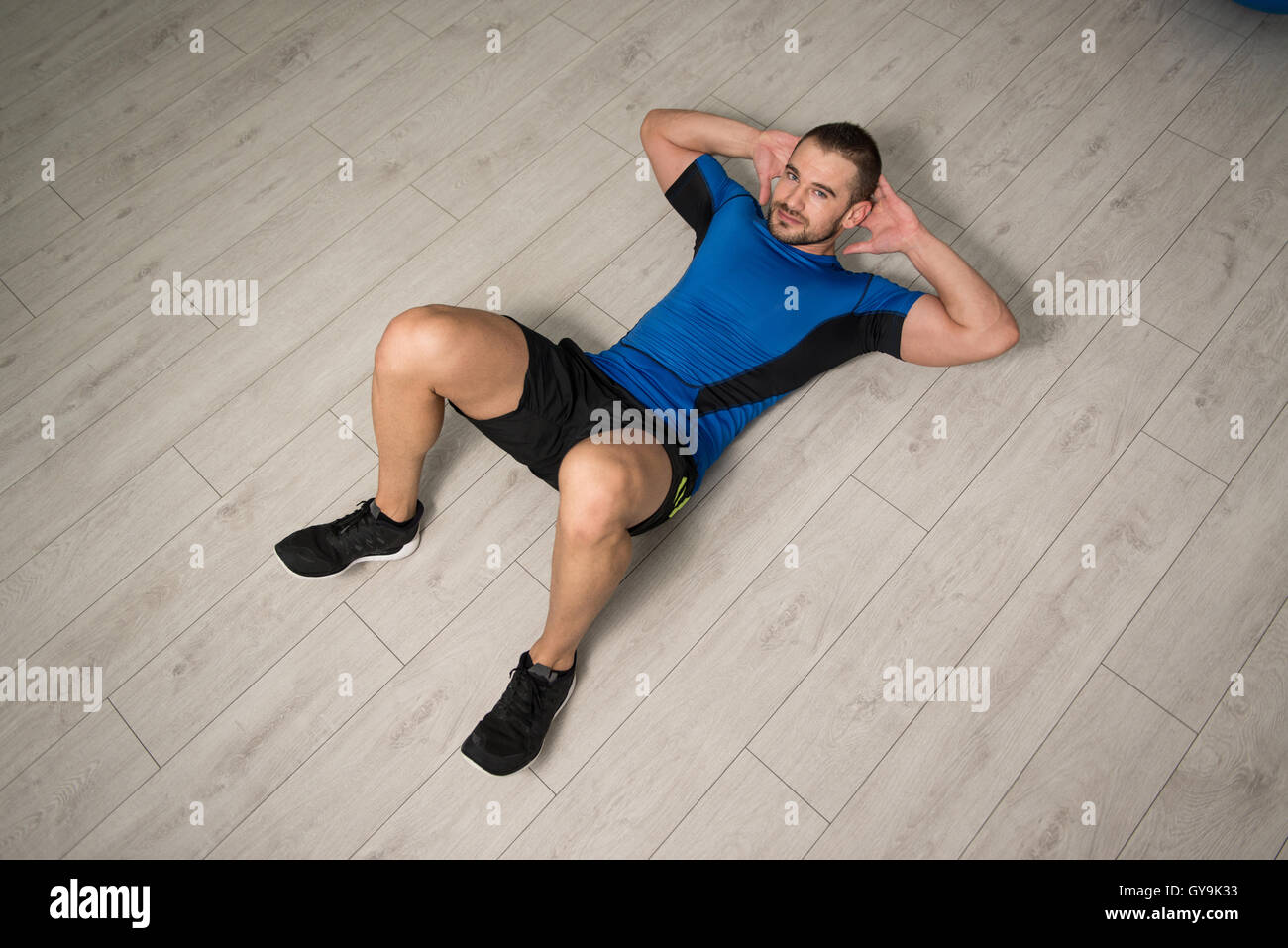 Personal Trainer Performing Abdominal Exercise On Floor - One Of The ...