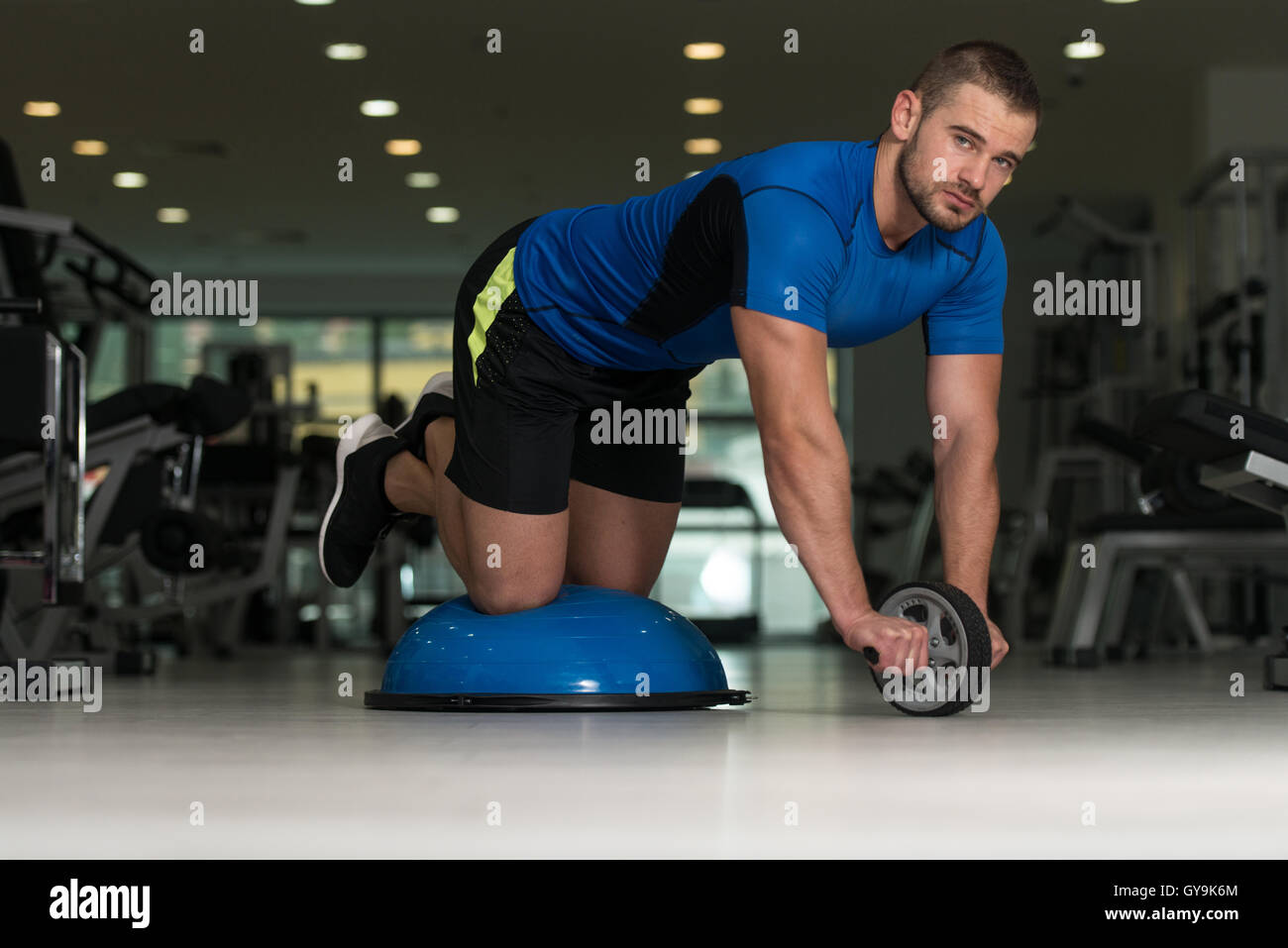 Personal Trainer Doing A Exercise For Abs With Bosu Balance Ball As ...