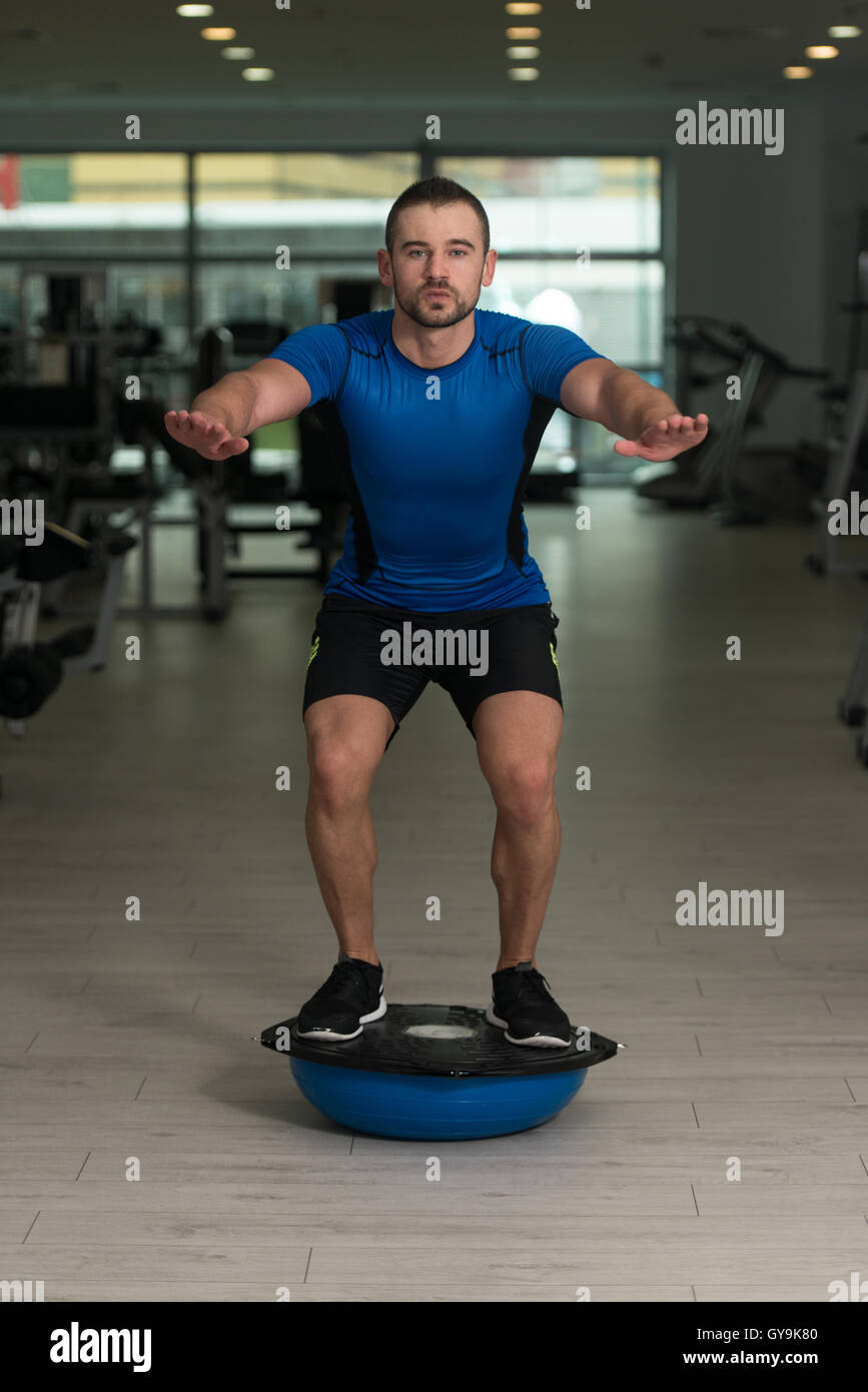 Personal Trainer Doing A Exercise With Bosu Balance Ball As Part Of ...
