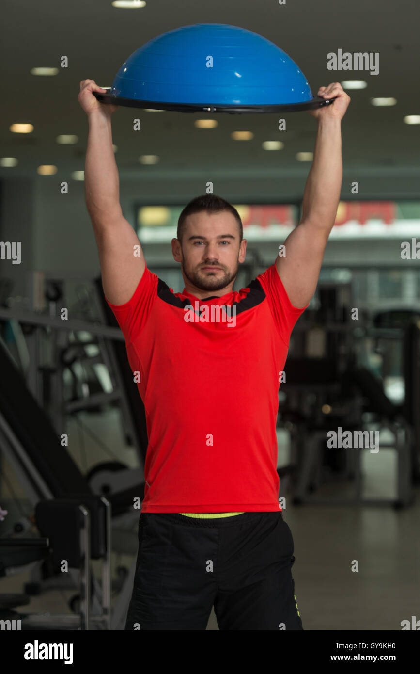 Personal Trainer Doing A Exercise With Bosu Balance Ball As Part Of ...