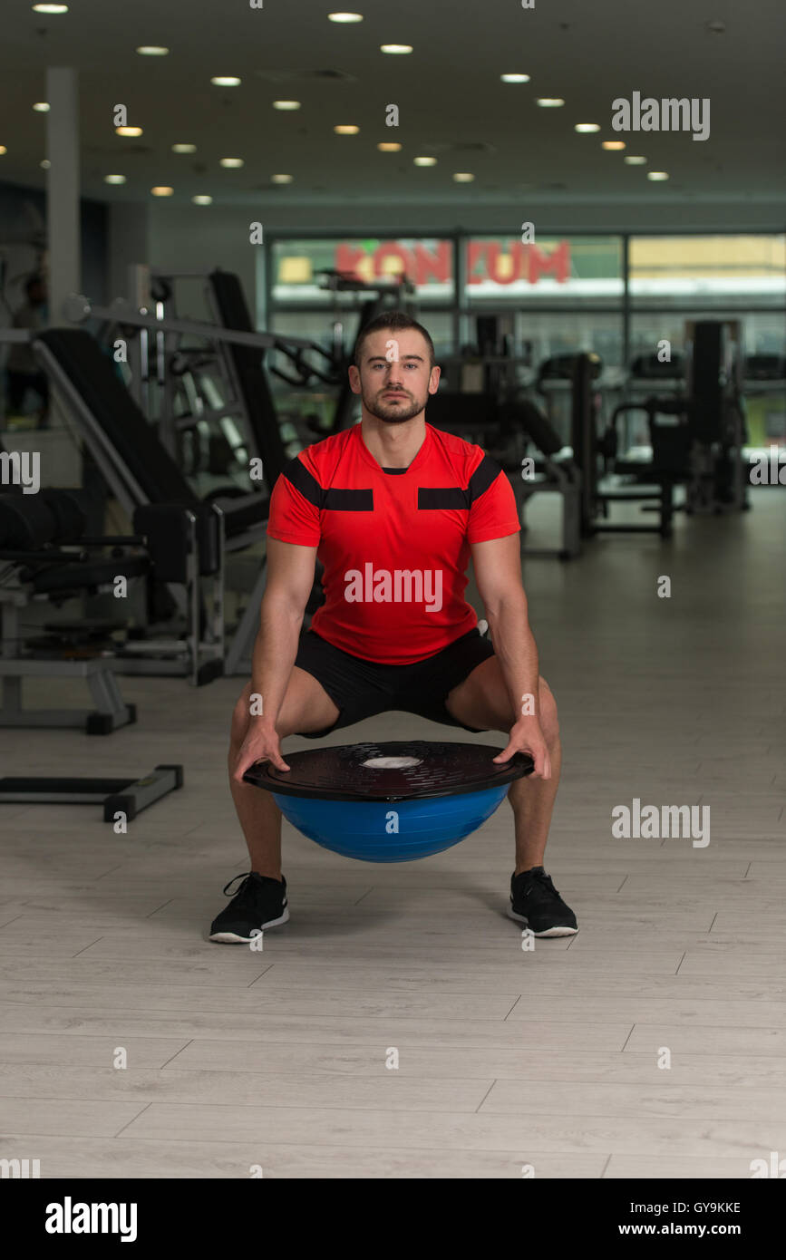 Personal Trainer Doing A Exercise With Bosu Balance Ball As Part Of ...