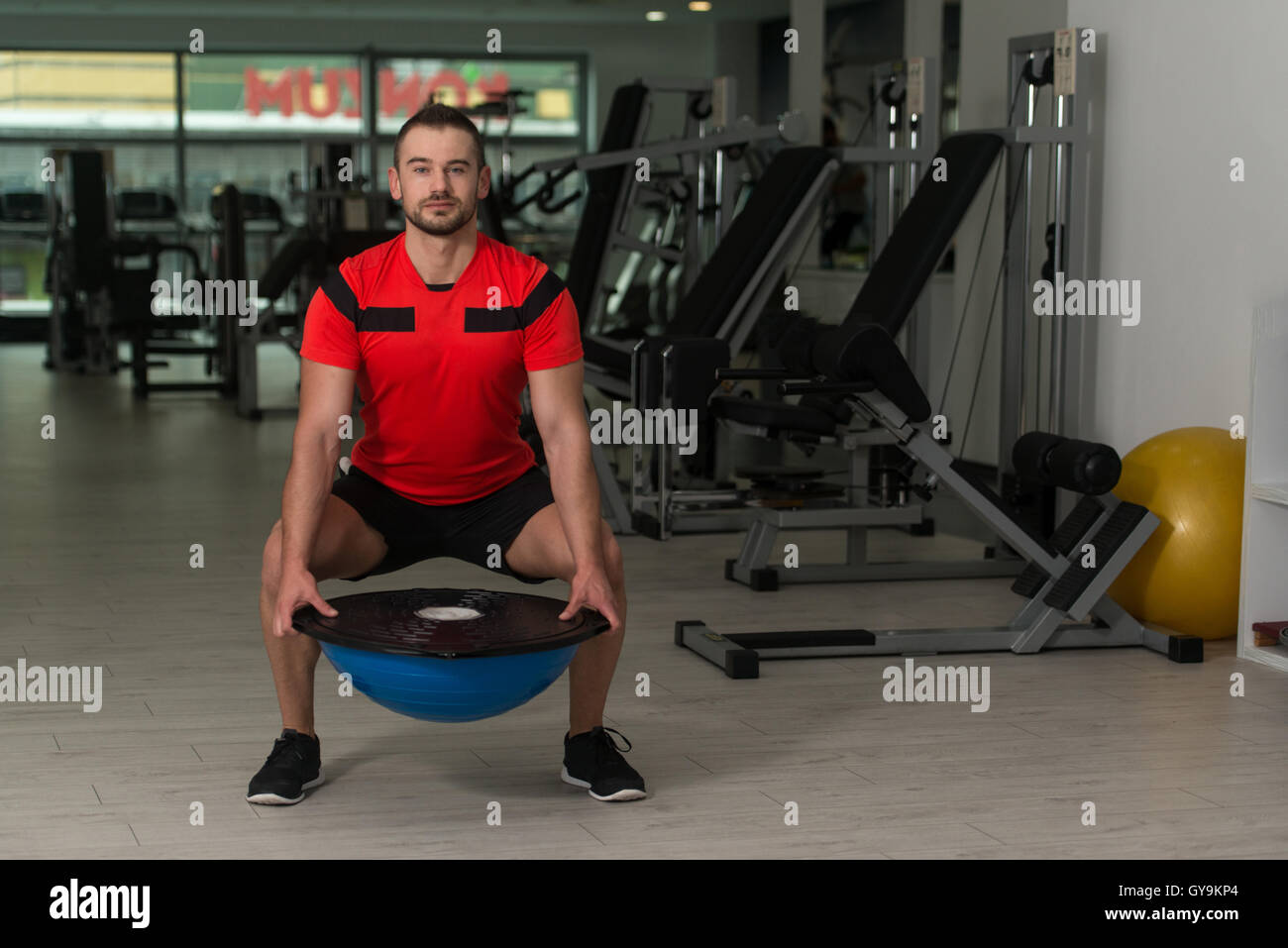 Personal Trainer Doing A Exercise With Bosu Balance Ball As Part Of ...