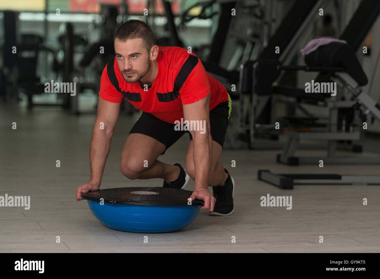 Personal Trainer Doing A Exercise With Bosu Balance Ball As Part Of ...