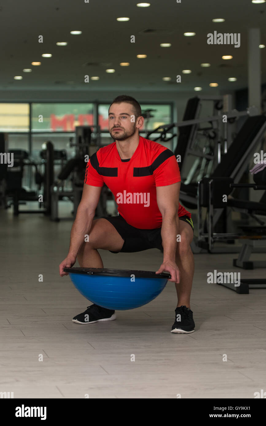 Personal Trainer Doing A Exercise With Bosu Balance Ball As Part Of ...