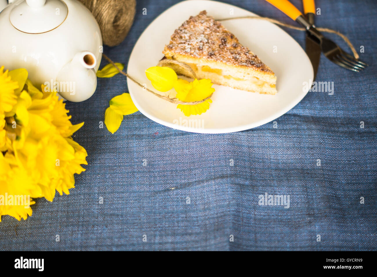 Apple pie, tea and daffodils on rustic table Stock Photo - Alamy