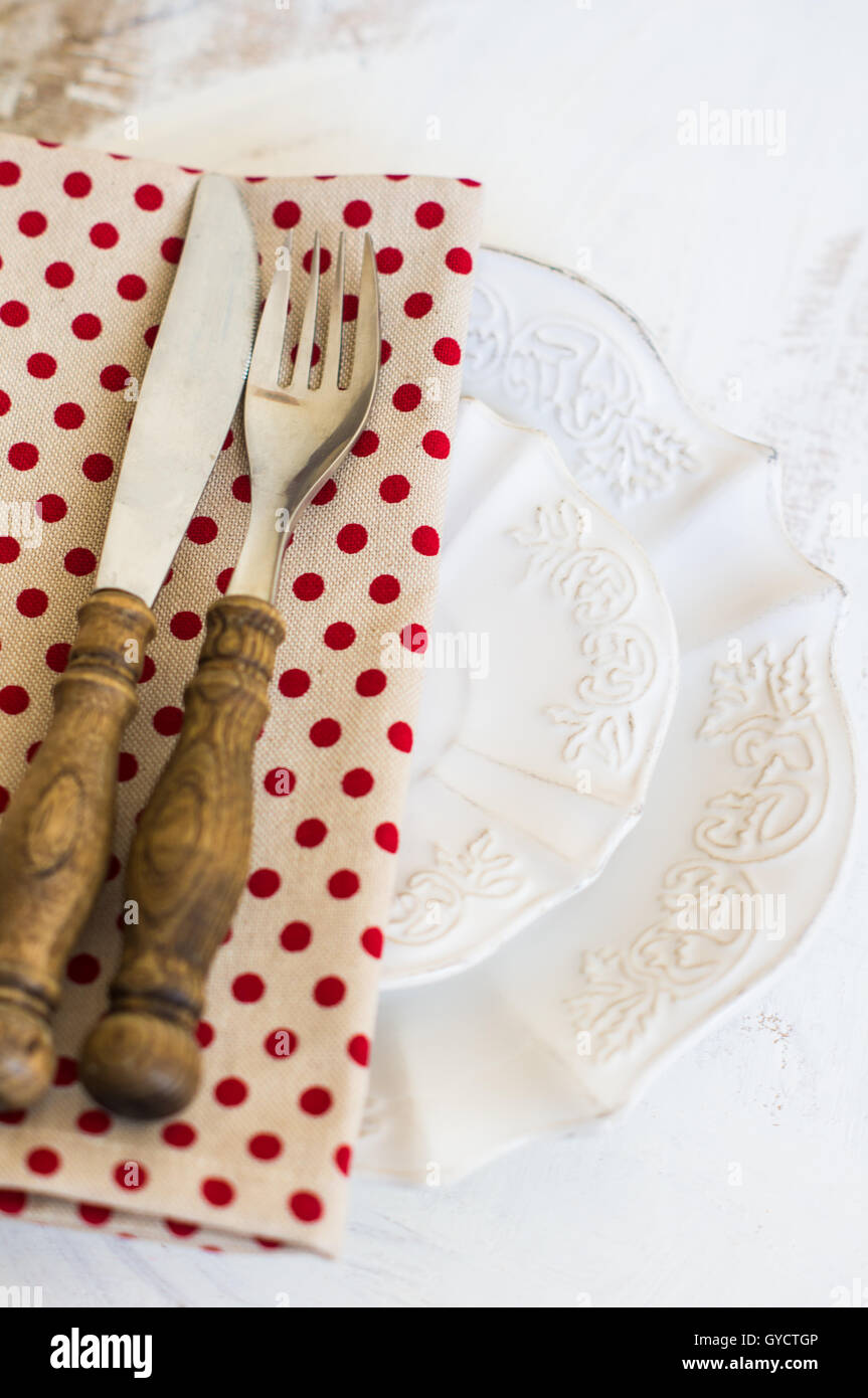 Table setting with vintage plate and silverware on rustic style napkin ...