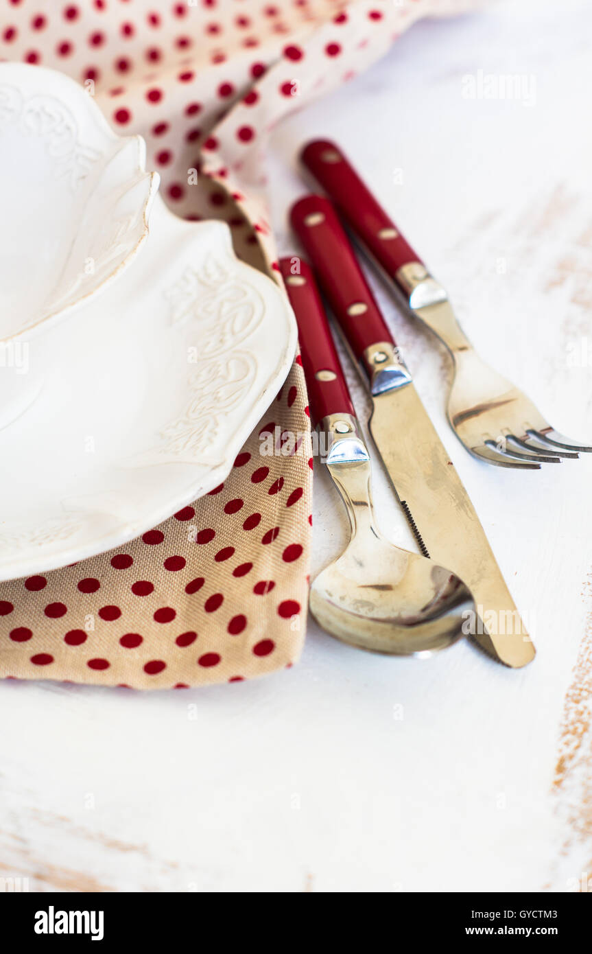 Table setting with vintage plate and silverware on rustic style napkin ...