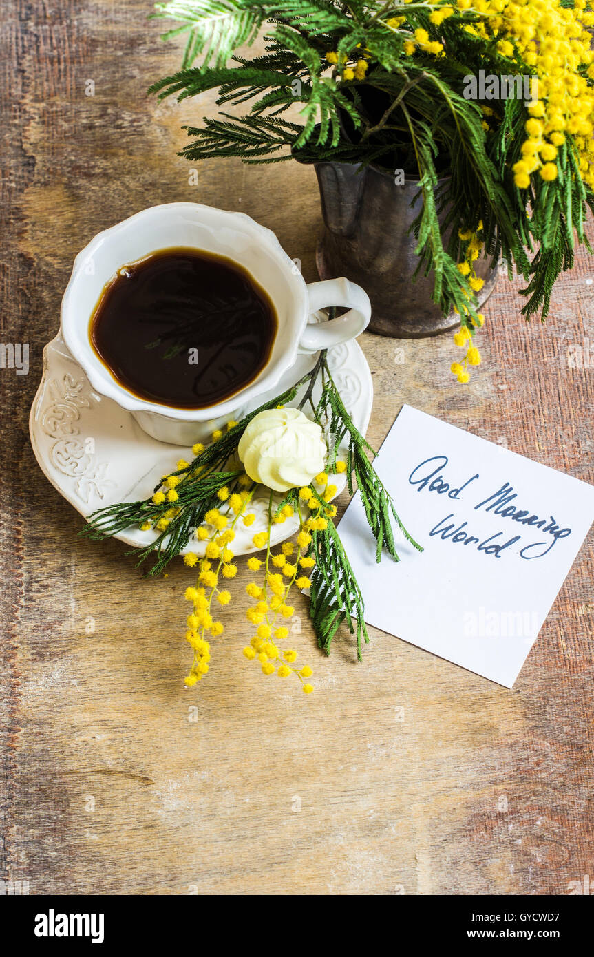 Cup of coffee and mimosa flowers on rustic wooden table Stock Photo - Alamy
