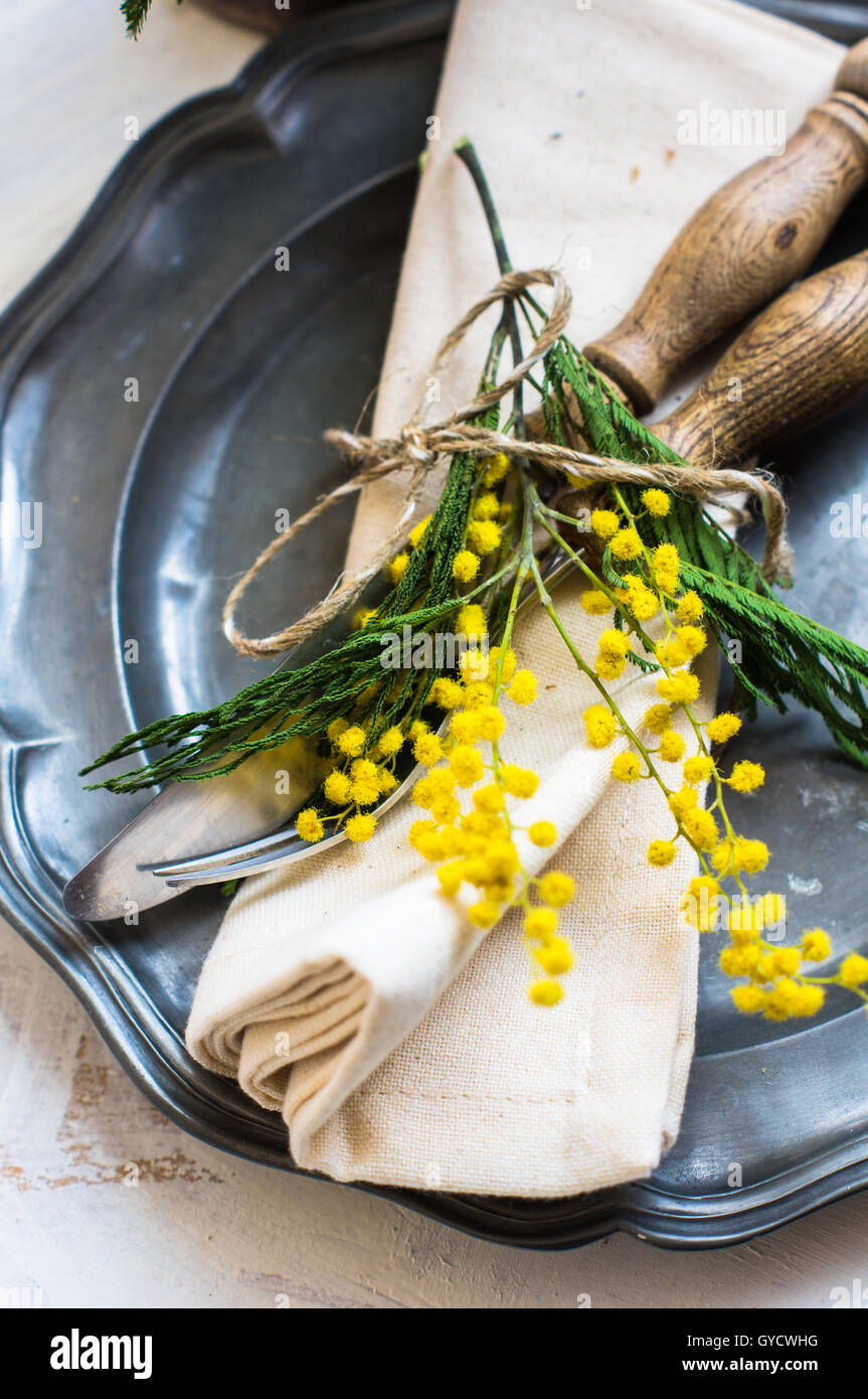 Table setting for Easter festive dinner with mimosa flowers Stock Photo ...