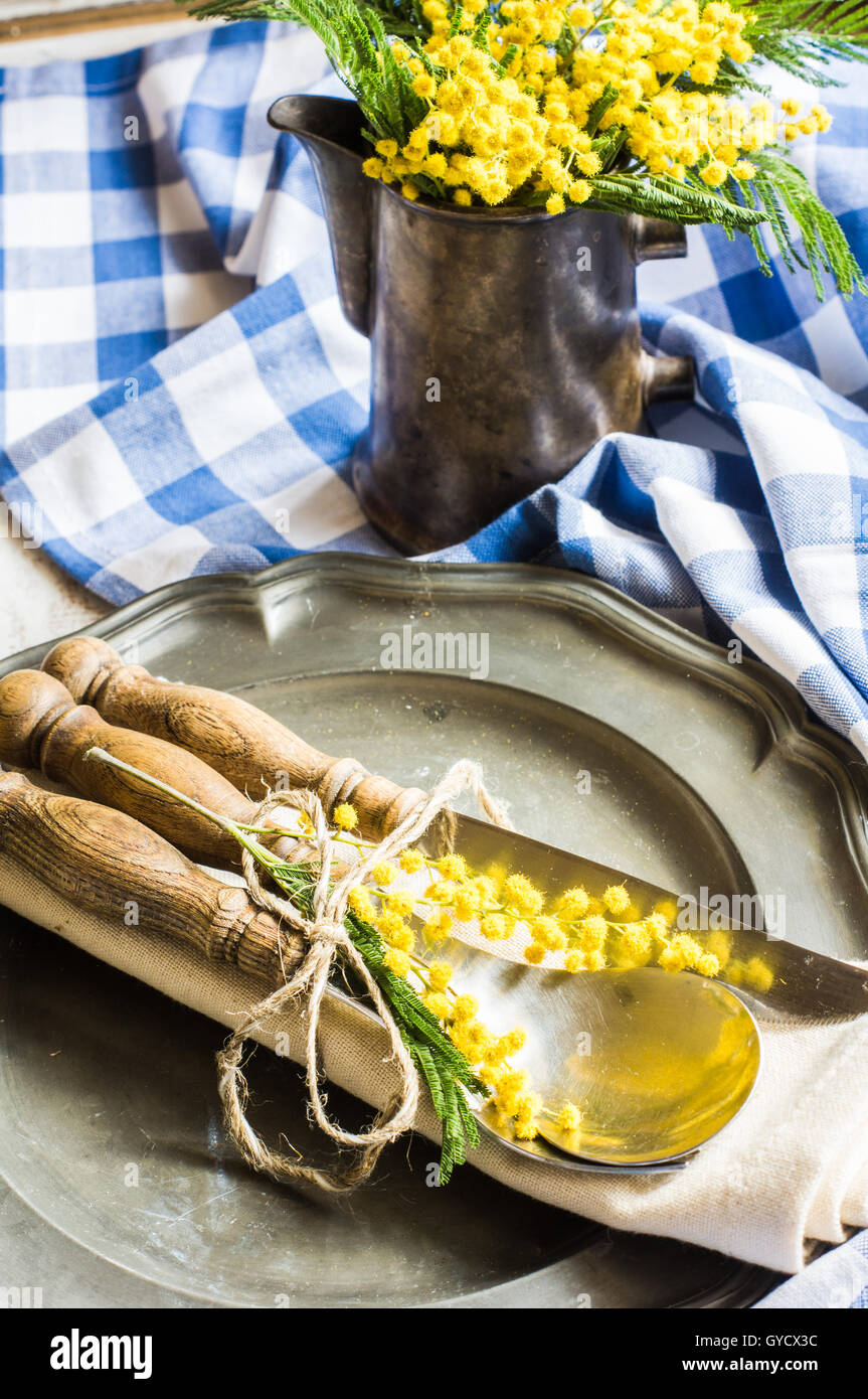 Table setting with mimosa flowers Stock Photo - Alamy